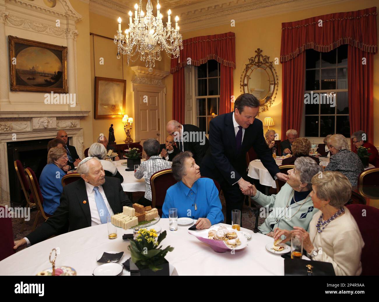 Britain's Prime Minister David Cameron, centre right, talks with guests ...