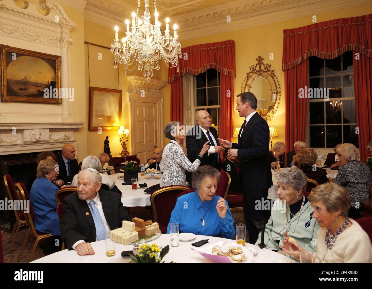 Britain's Prime Minister David Cameron, centre right, talks with guests ...