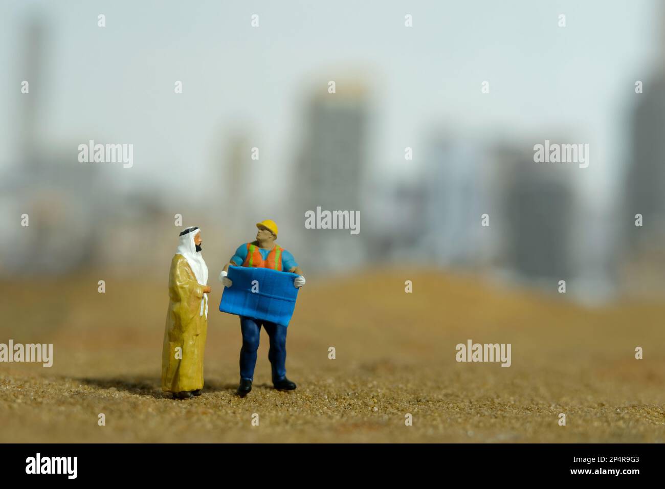 Miniature people toy figure photography. City or country development. A ...