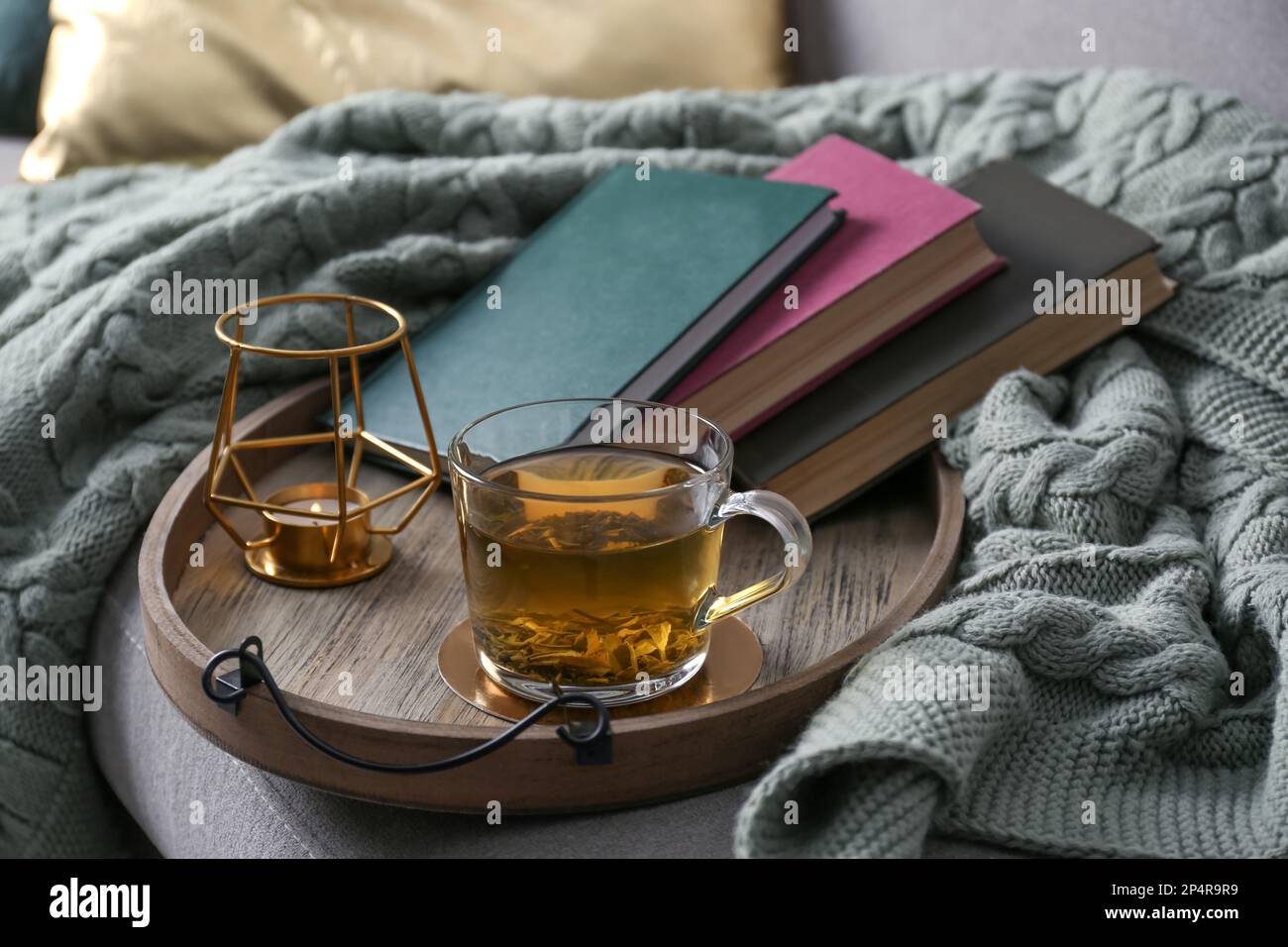 Stylish tray with different interior elements and tea on sofa Stock ...