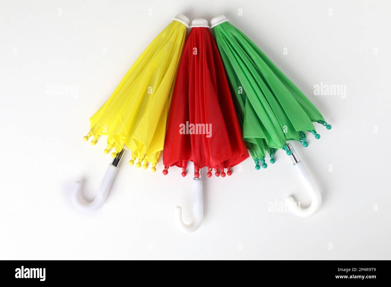 Small color umbrellas on white background, top view Stock Photo - Alamy