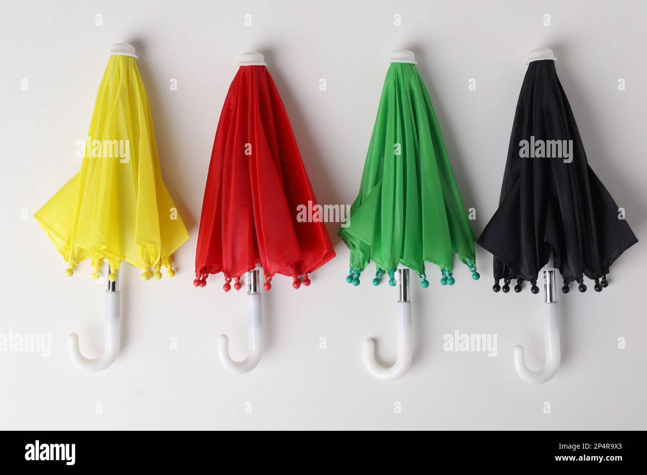 Small color umbrellas on white background, top view Stock Photo - Alamy