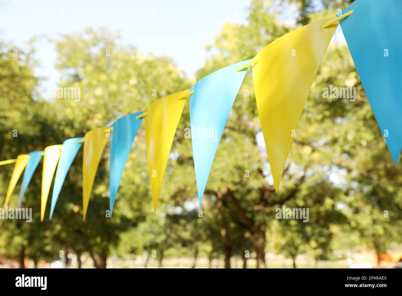 Colorful bunting flags in park. Party decor Stock Photo - Alamy