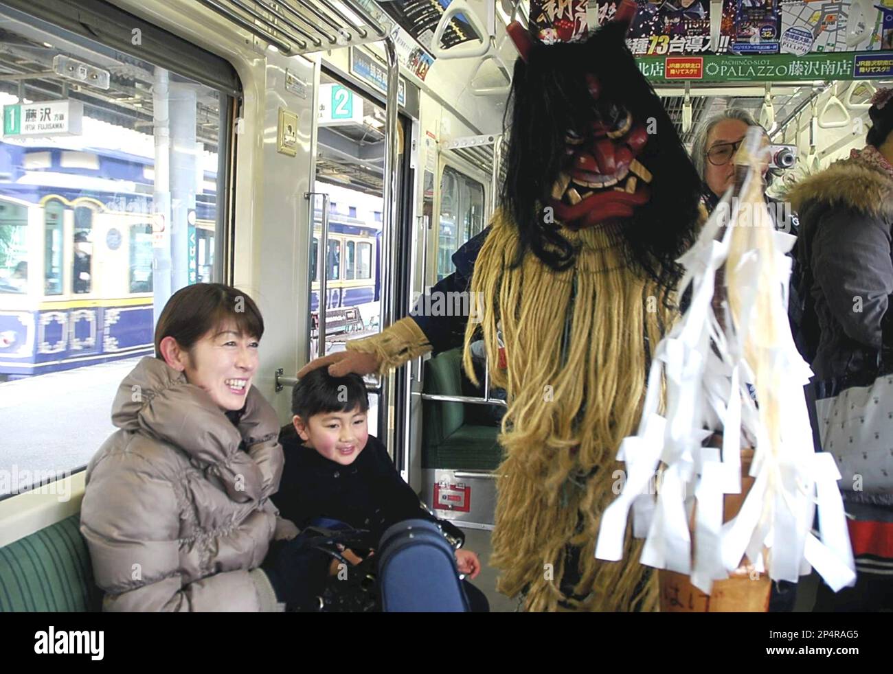 A man dressed as a namahage demon-god glares at passengers on the ...