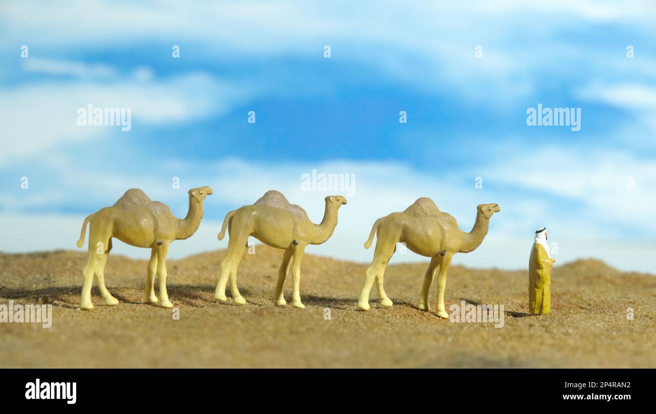 Miniature people toy figure photography. Middle eastern man wearing ...