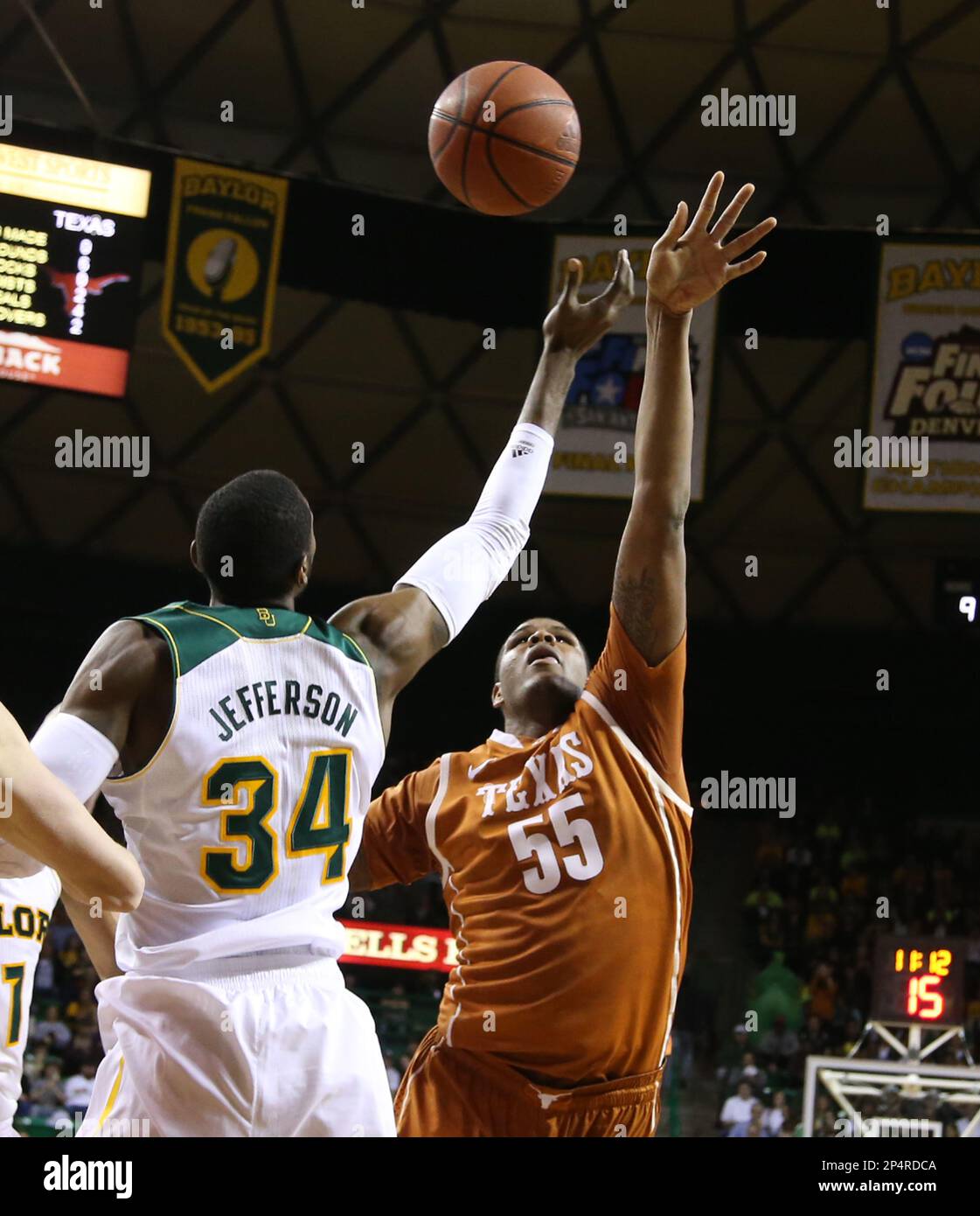 Texas center Cameron Ridley (55) reaches for a rebound with Baylor ...