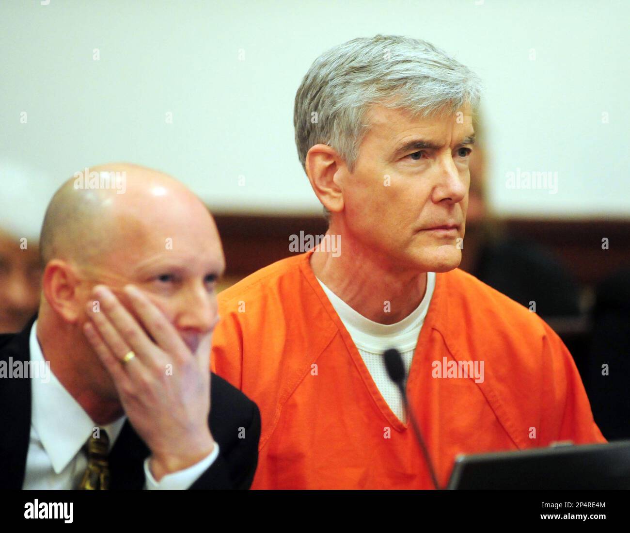 Attorney Greg Parzych and Steven Democker listen to a letter being read ...