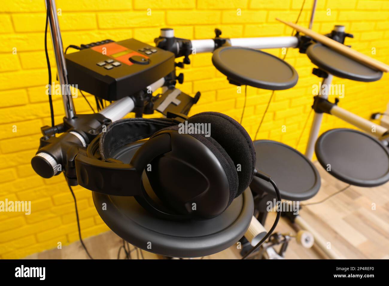 Modern electronic drum kit with headphones indoors. Musical instrument ...