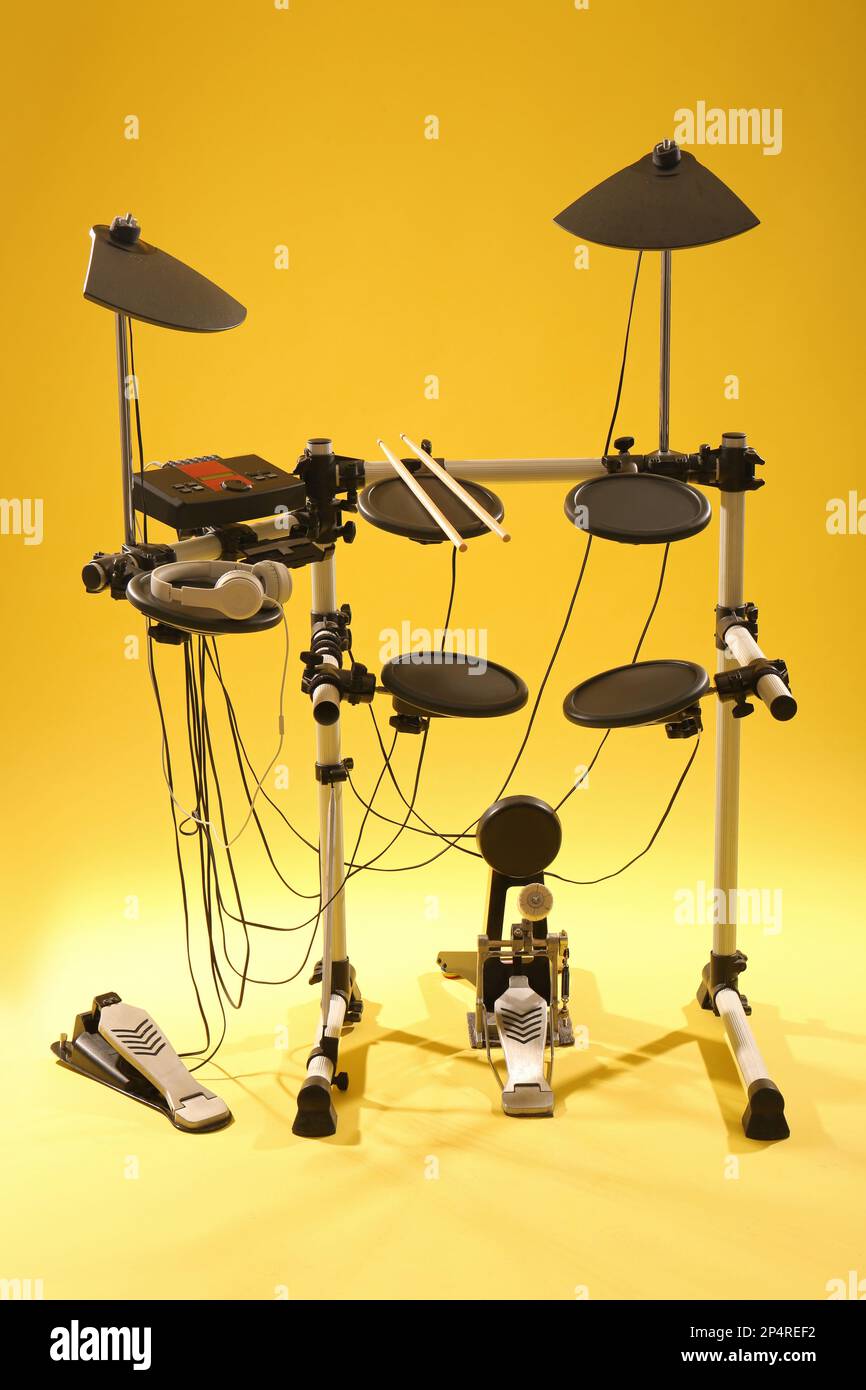 Modern electronic drum kit on yellow background. Musical instrument ...