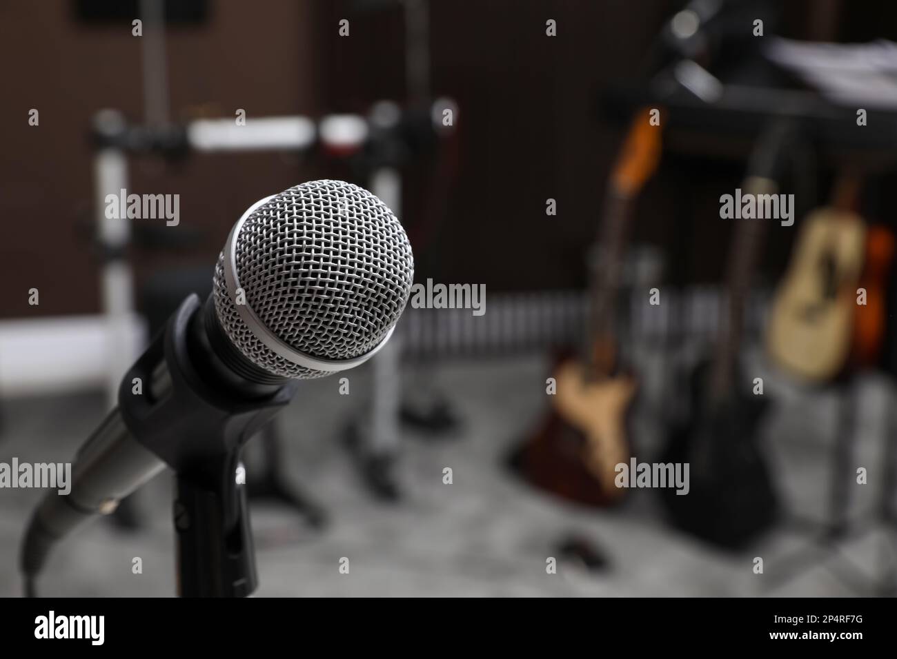 Modern microphone at recording studio, space for text. Music band ...