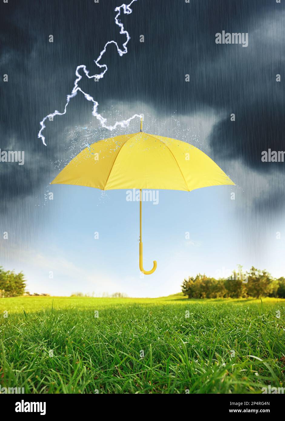 Open yellow umbrella under heavy rain in green meadow Stock Photo - Alamy