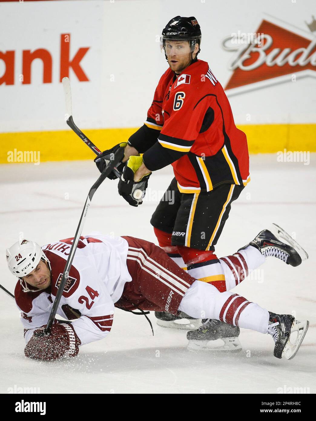 Phoenix Coyotes' Kyle Chipchura, left, gets knocked to the ice by ...