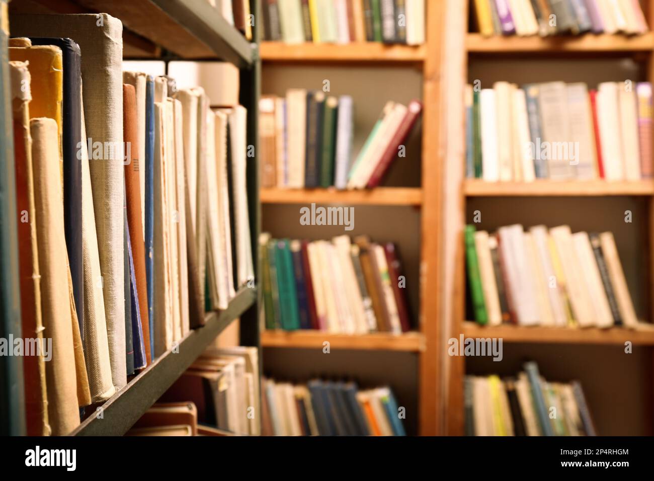 Collection of different books on shelves in library Stock Photo - Alamy