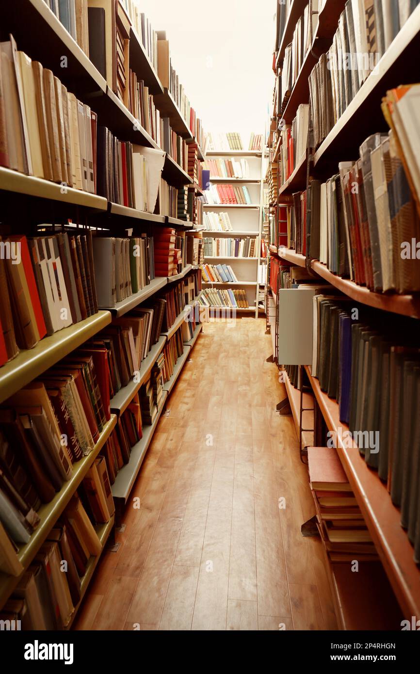 Collection of different books on shelves in library Stock Photo - Alamy