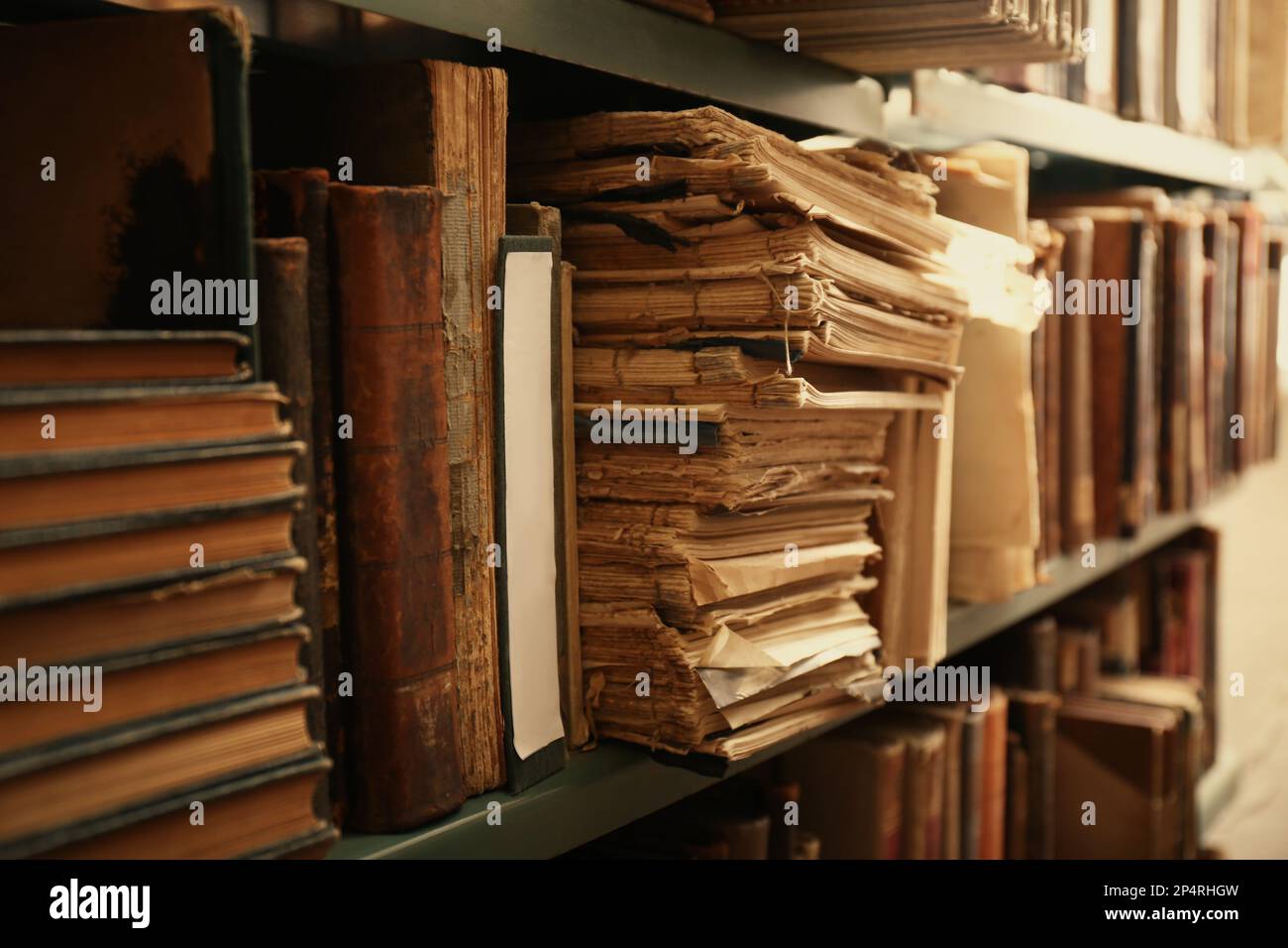 Collection of old books on shelves in library Stock Photo - Alamy