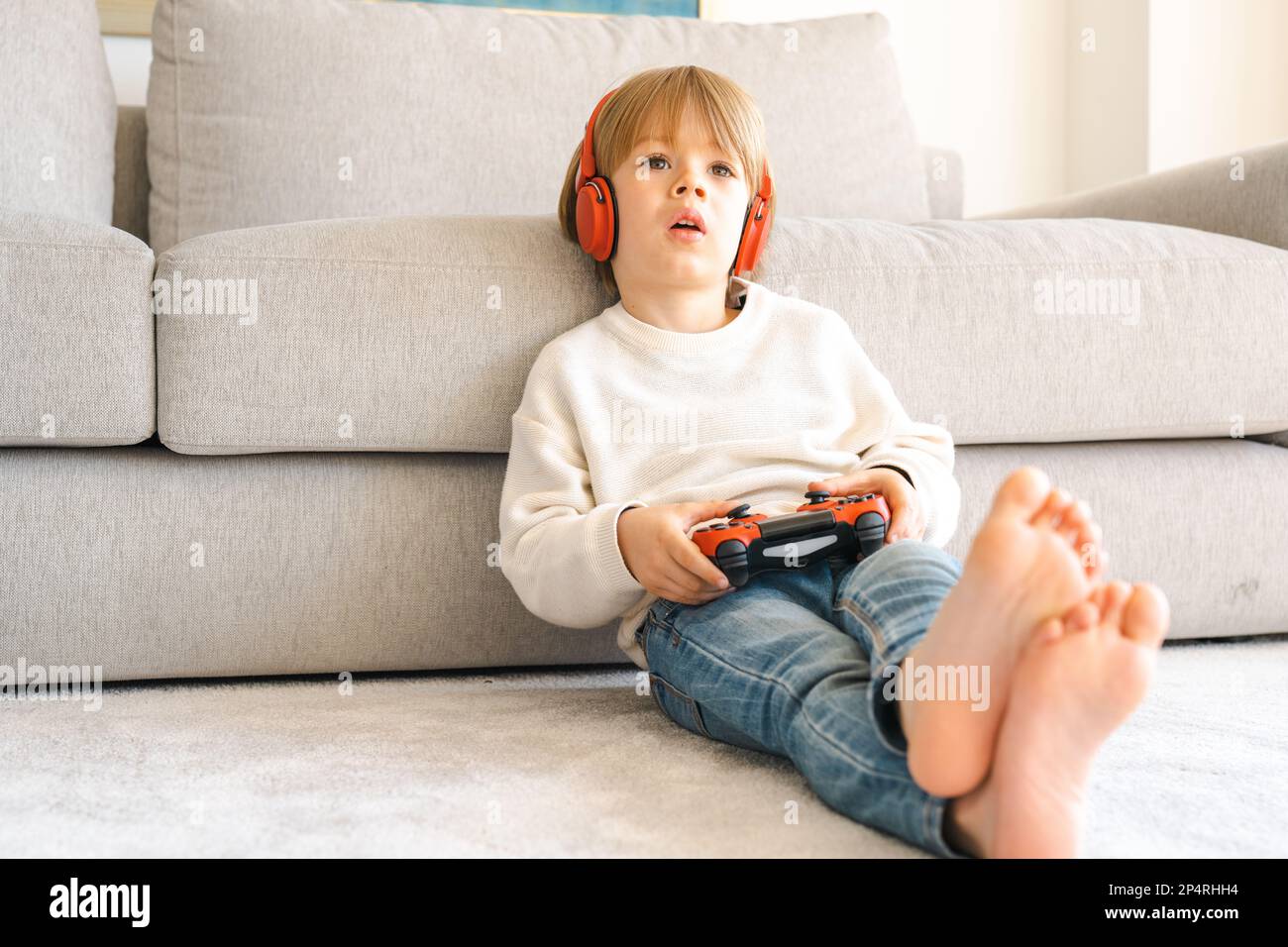 Little boy playing video game console using joystick or controller ...