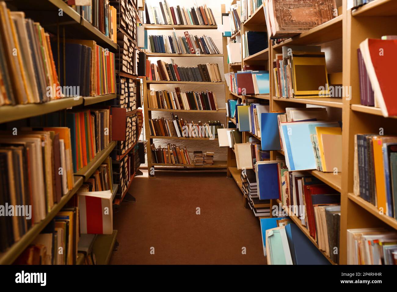 Collection of different books on shelves in library Stock Photo - Alamy