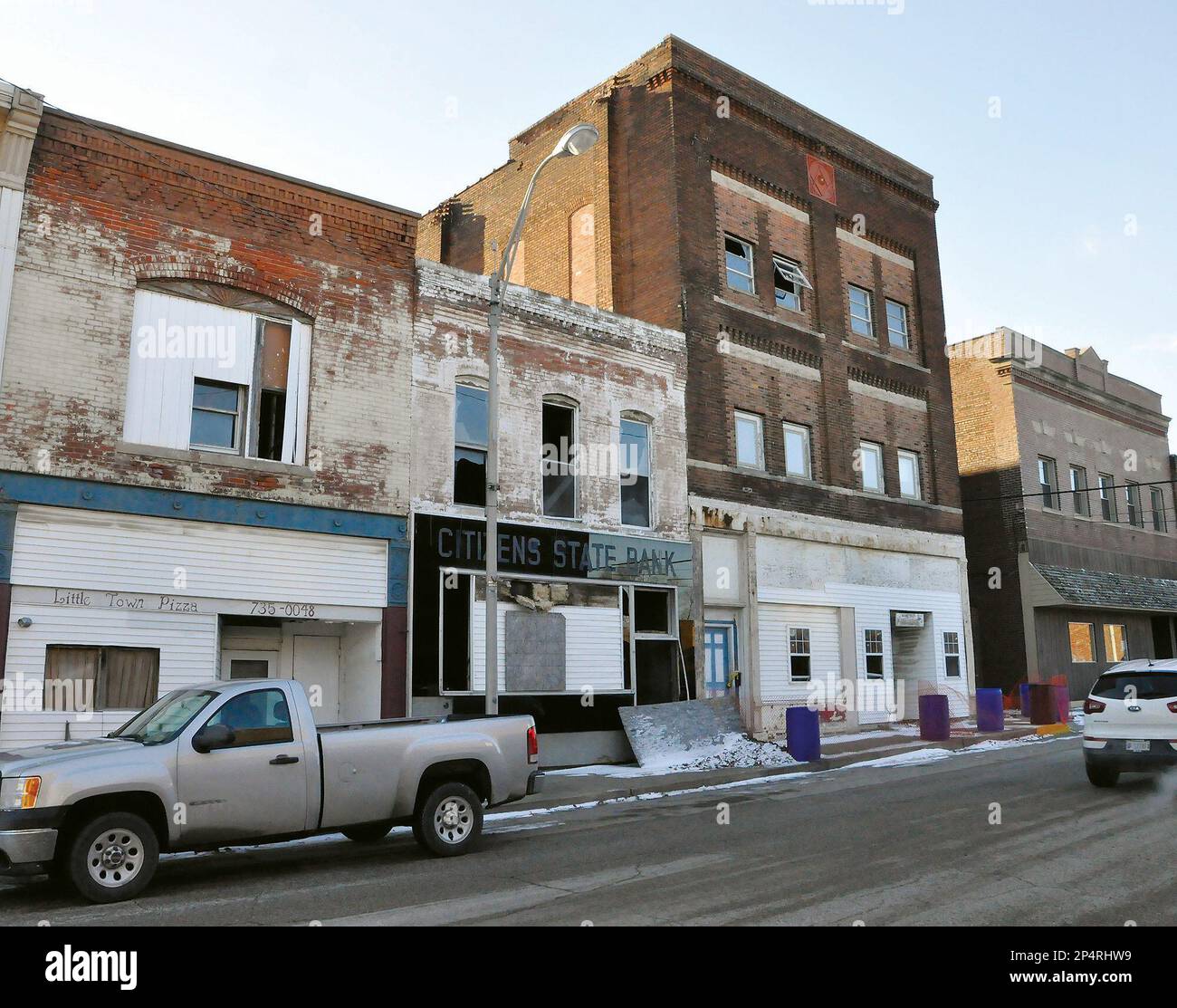 This Wednesday Jan. 22, 2014 photo shows three condemned buildings in ...