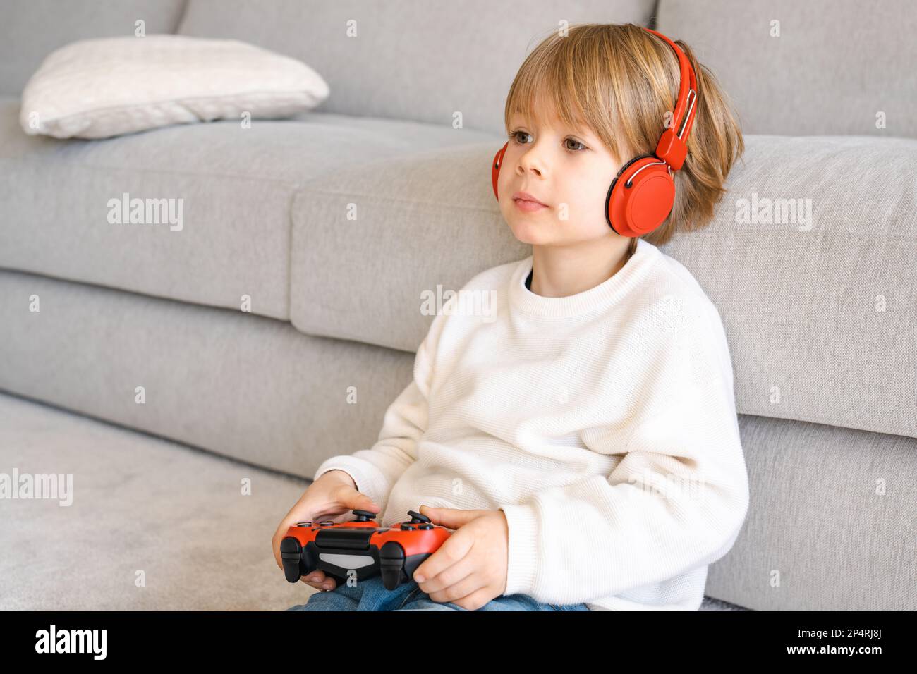 Little boy playing video game console using joystick or controller ...