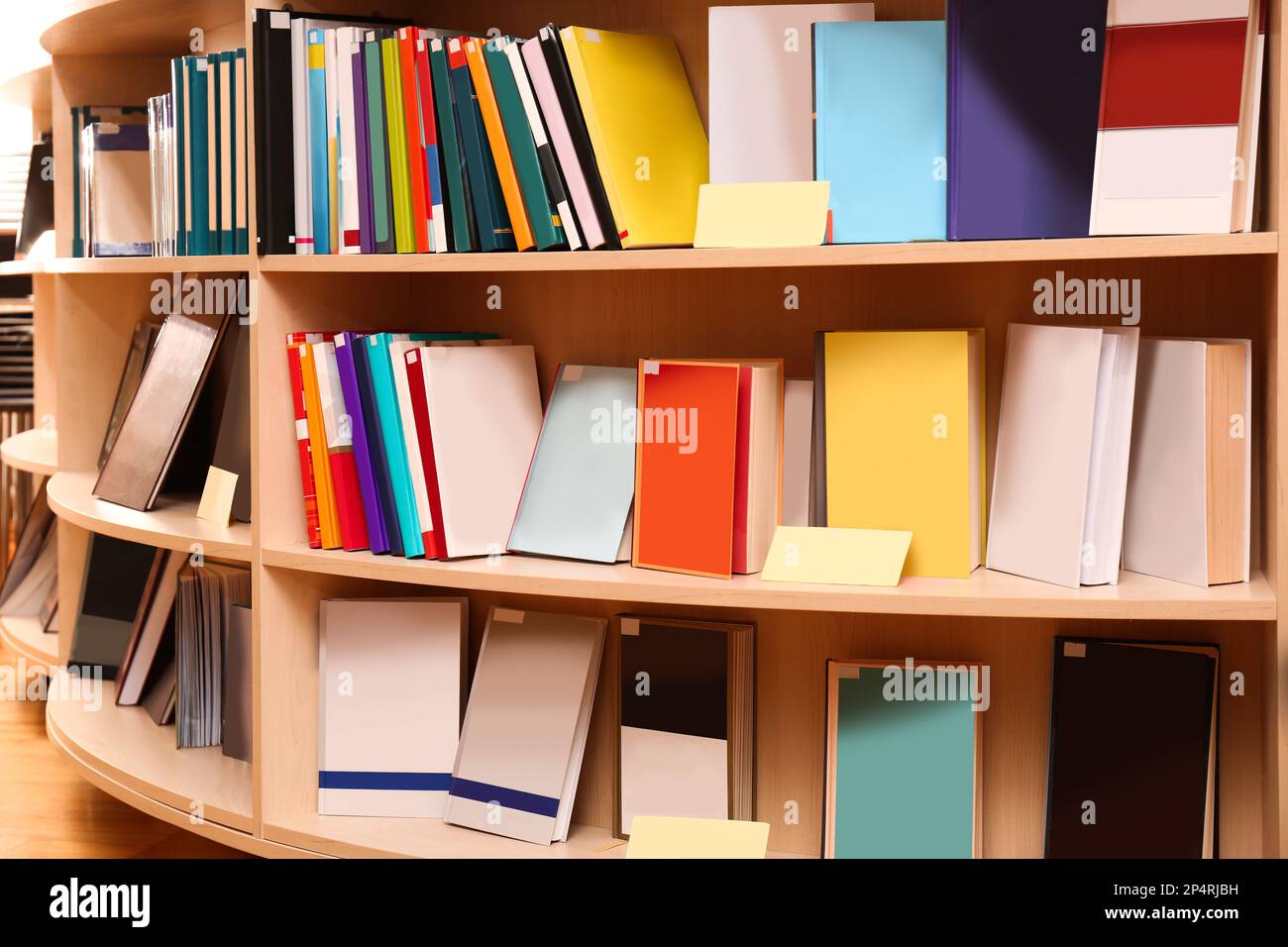 Collection of different books on shelves in library Stock Photo - Alamy