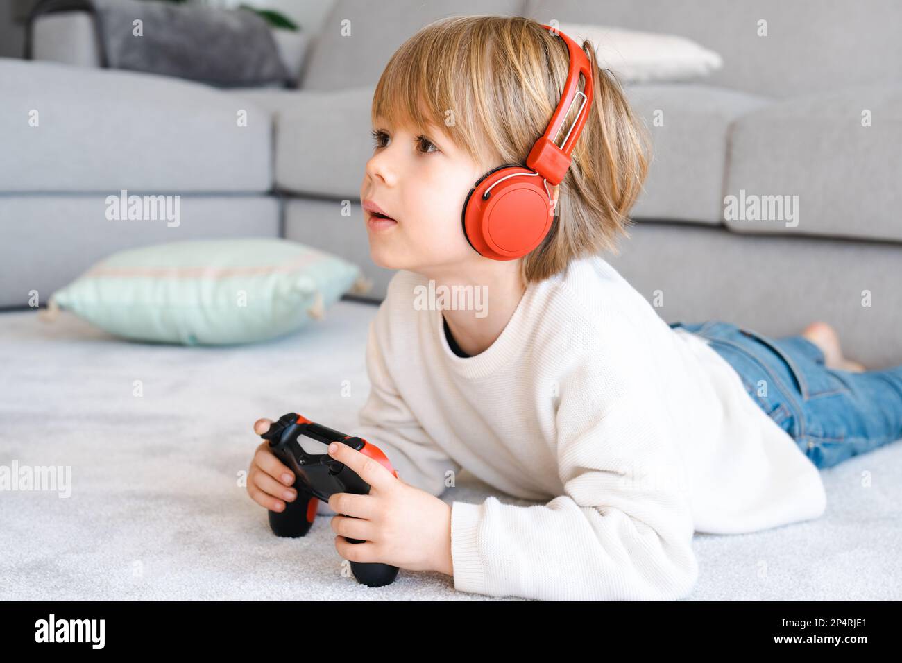 Little boy playing video game console using joystick or controller ...