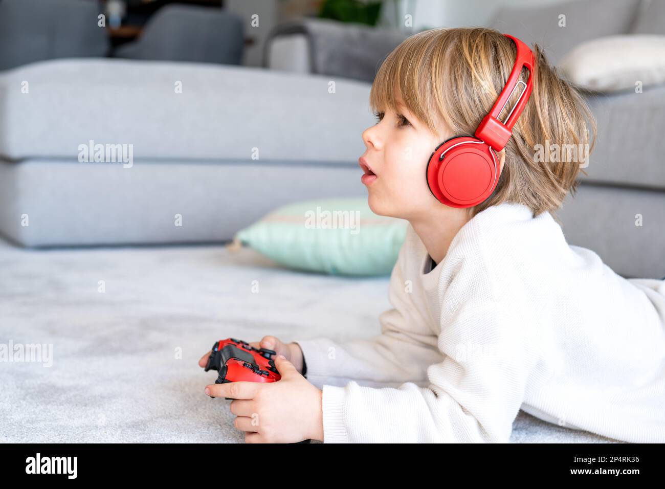 Little boy playing video game console using joystick or controller ...