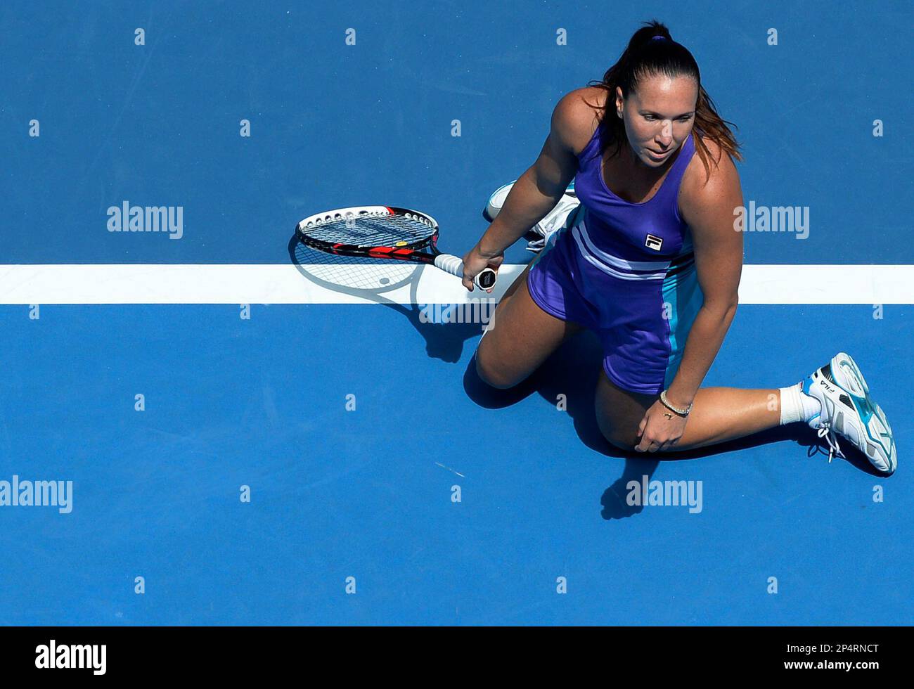 Jelena Jankovic of Serbia falls to the court during her fourth round ...