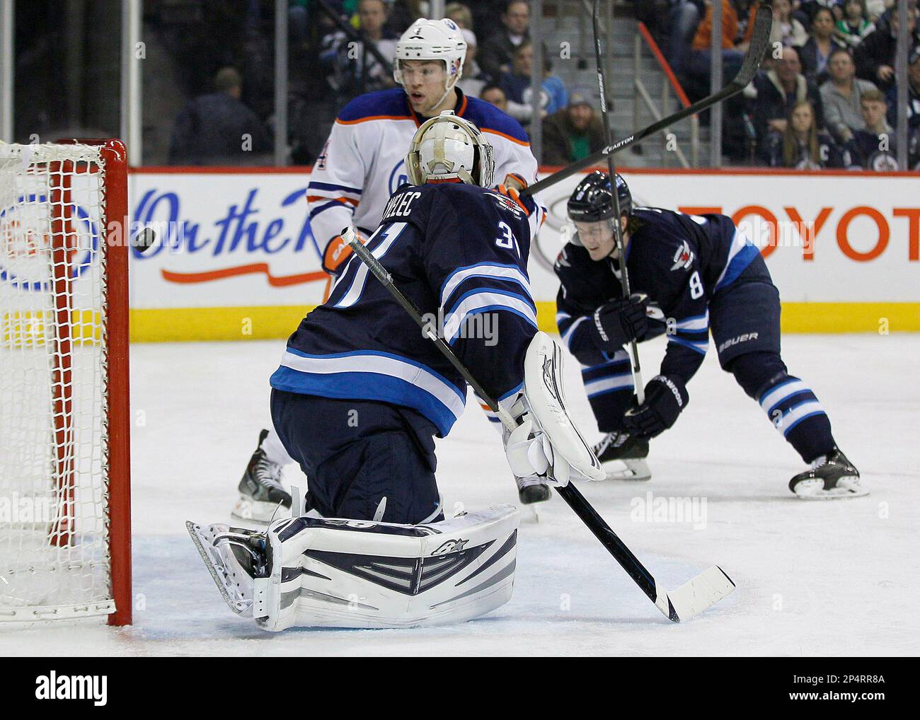 Edmonton Oilers' Taylor Hall (4) and Winnipeg Jets' Jacob Trouba (8 ...