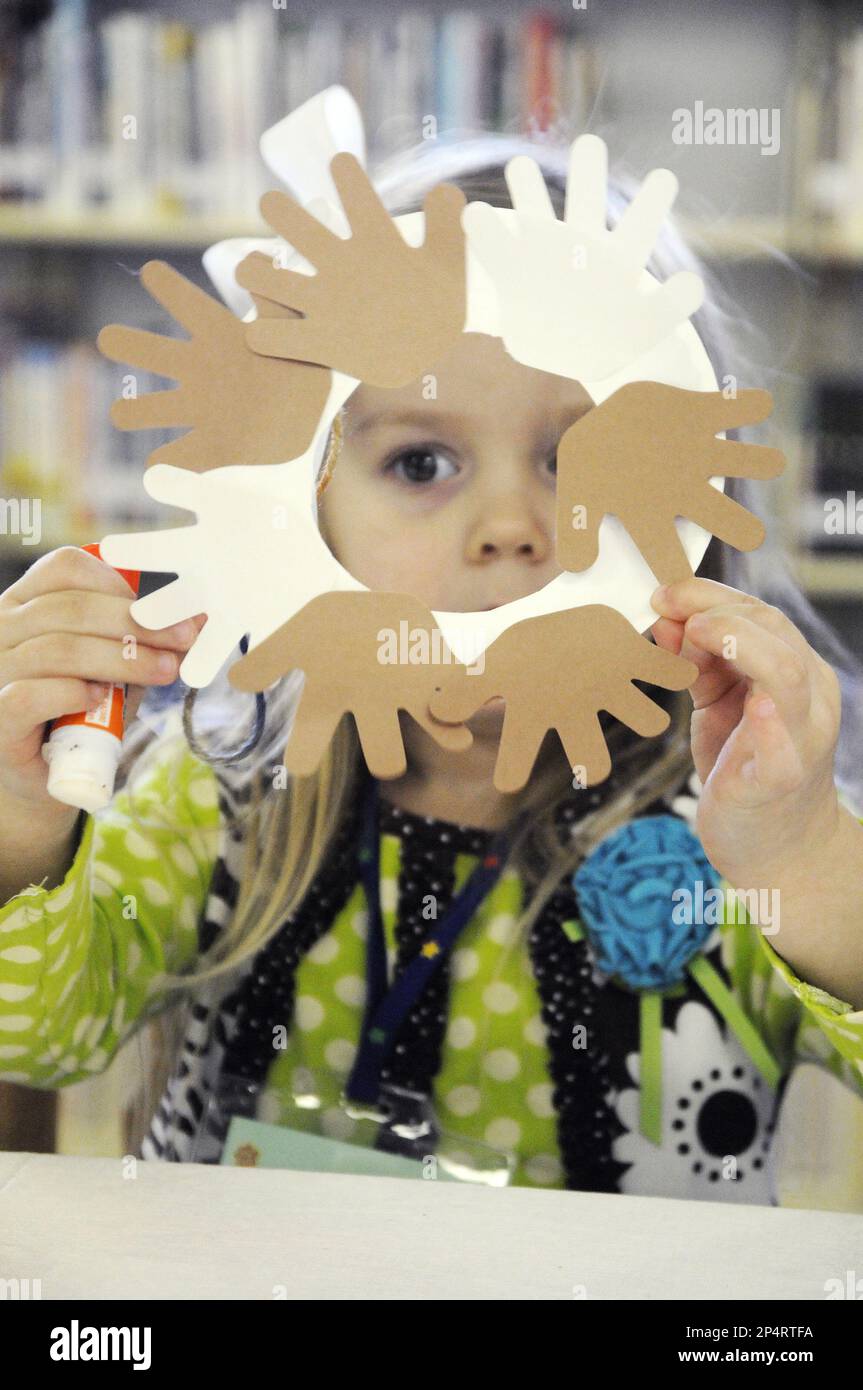 Caroline Boothe, 4, shows off her friendship wreath craft during story ...