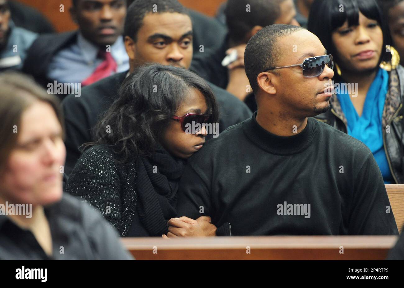 Tanesha Reed hugs her husband Carl as they listen to testimony in a ...