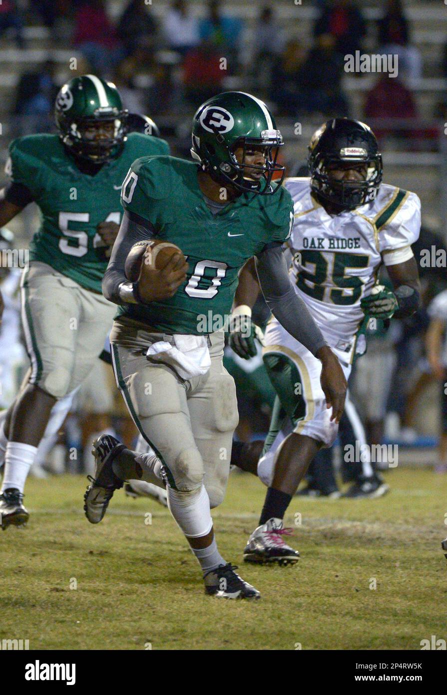 Evans quarterback Ervin Barrett (10) scrambles past Oak Ridge ...