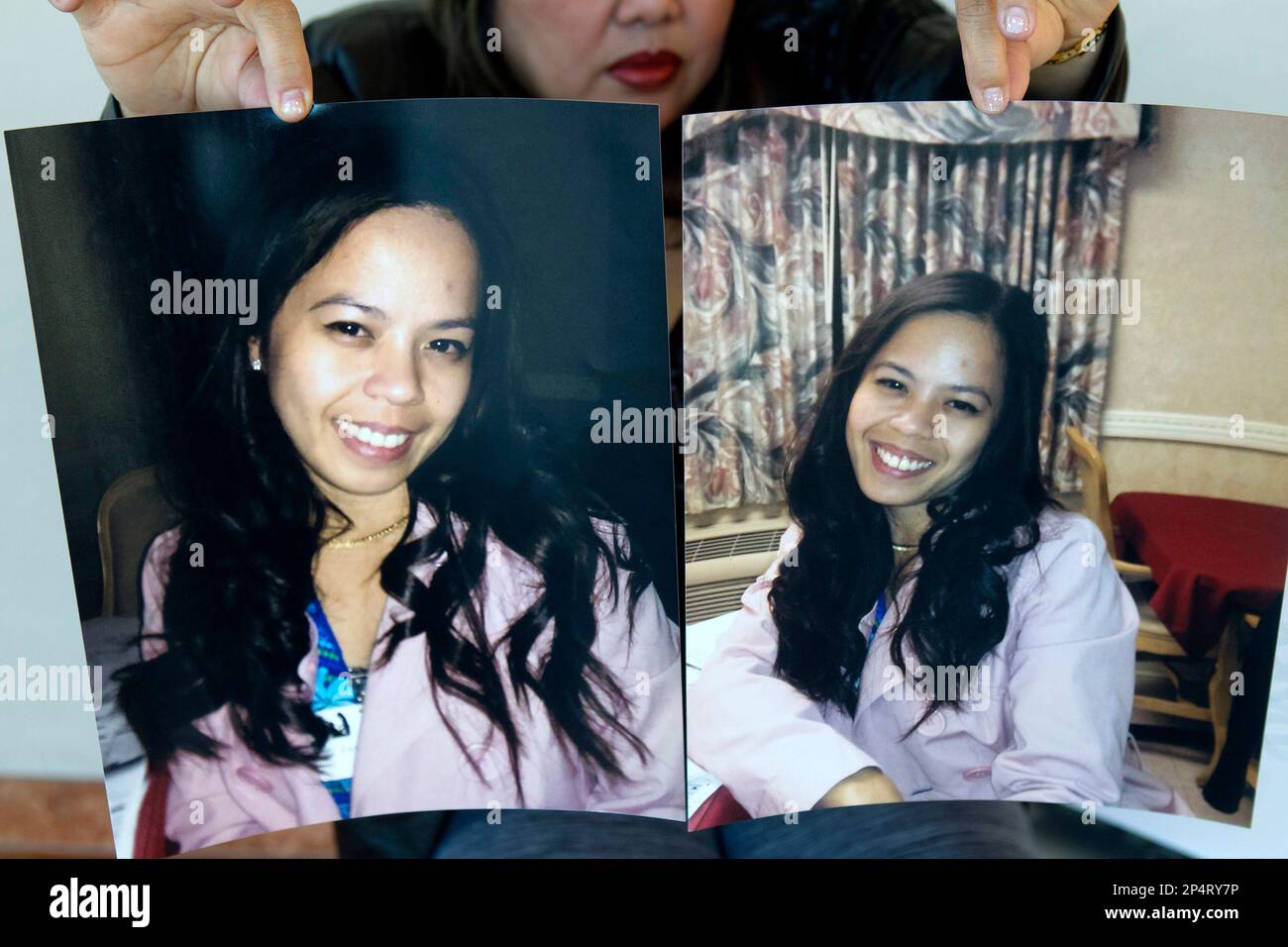 A co-worker holds photos of victim Daisy Dahan before court at the ...