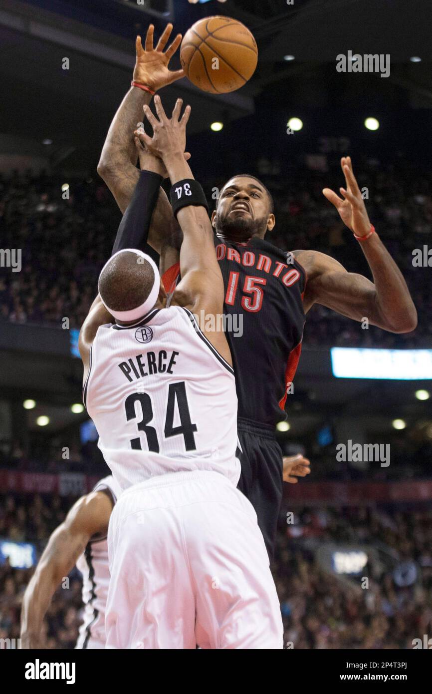 Toronto Raptors' Amir Johnson (15) shoots as Brooklyn Nets' Paul Pierce ...
