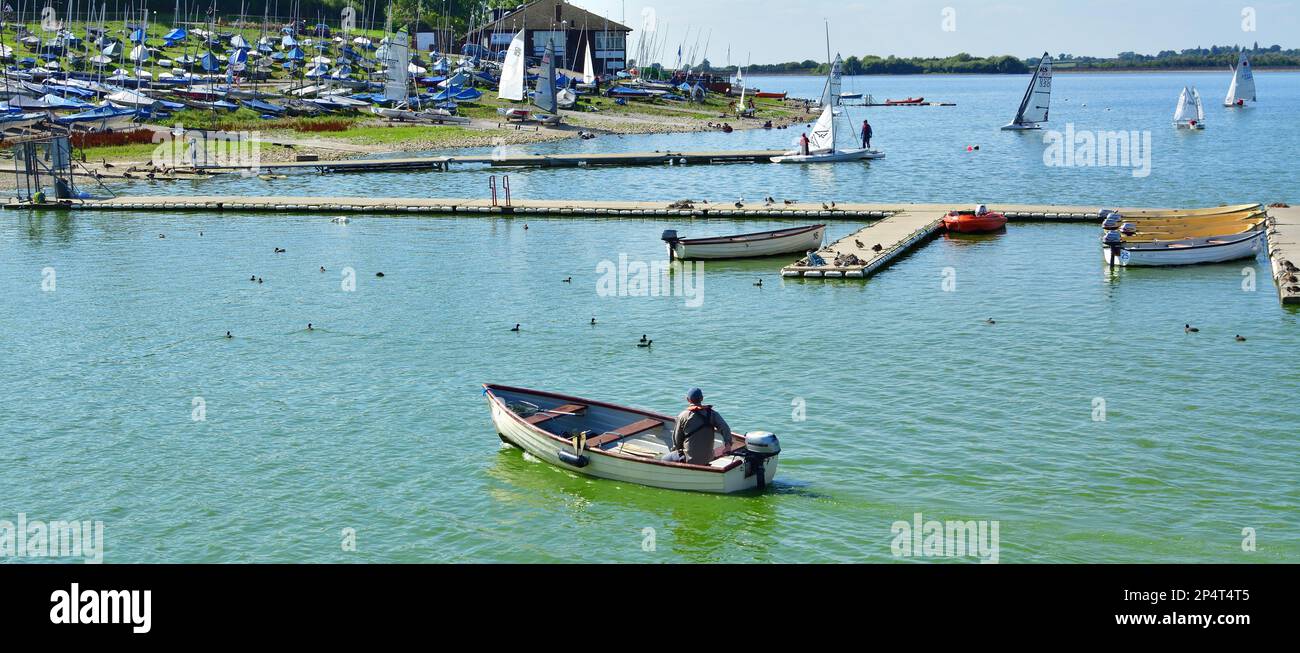 A bustling harbor with multiple boats and motorboats docked in the ...