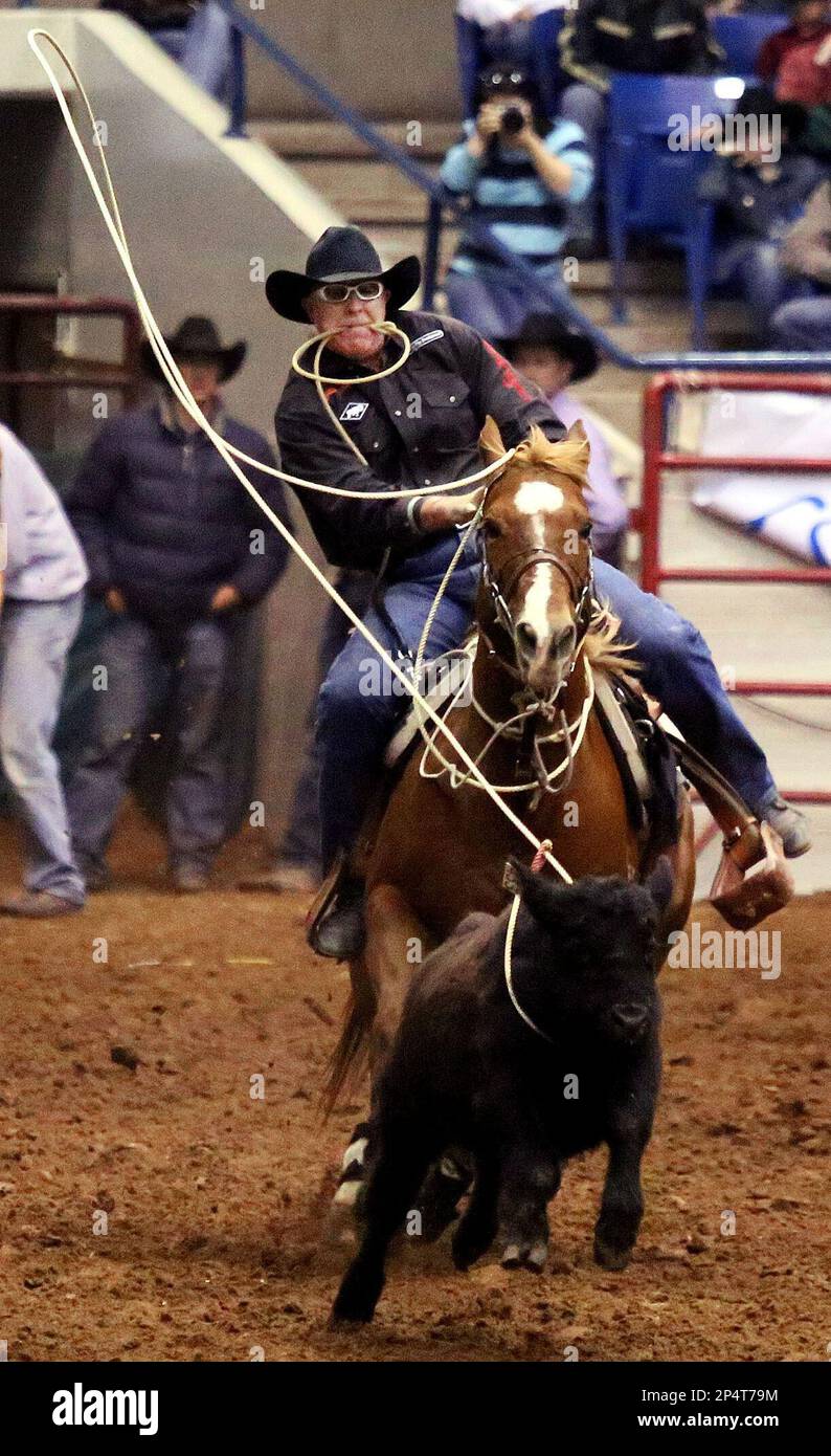 Mike Johnson ropes a calf and ties it down in 13.9 seconds during the ...