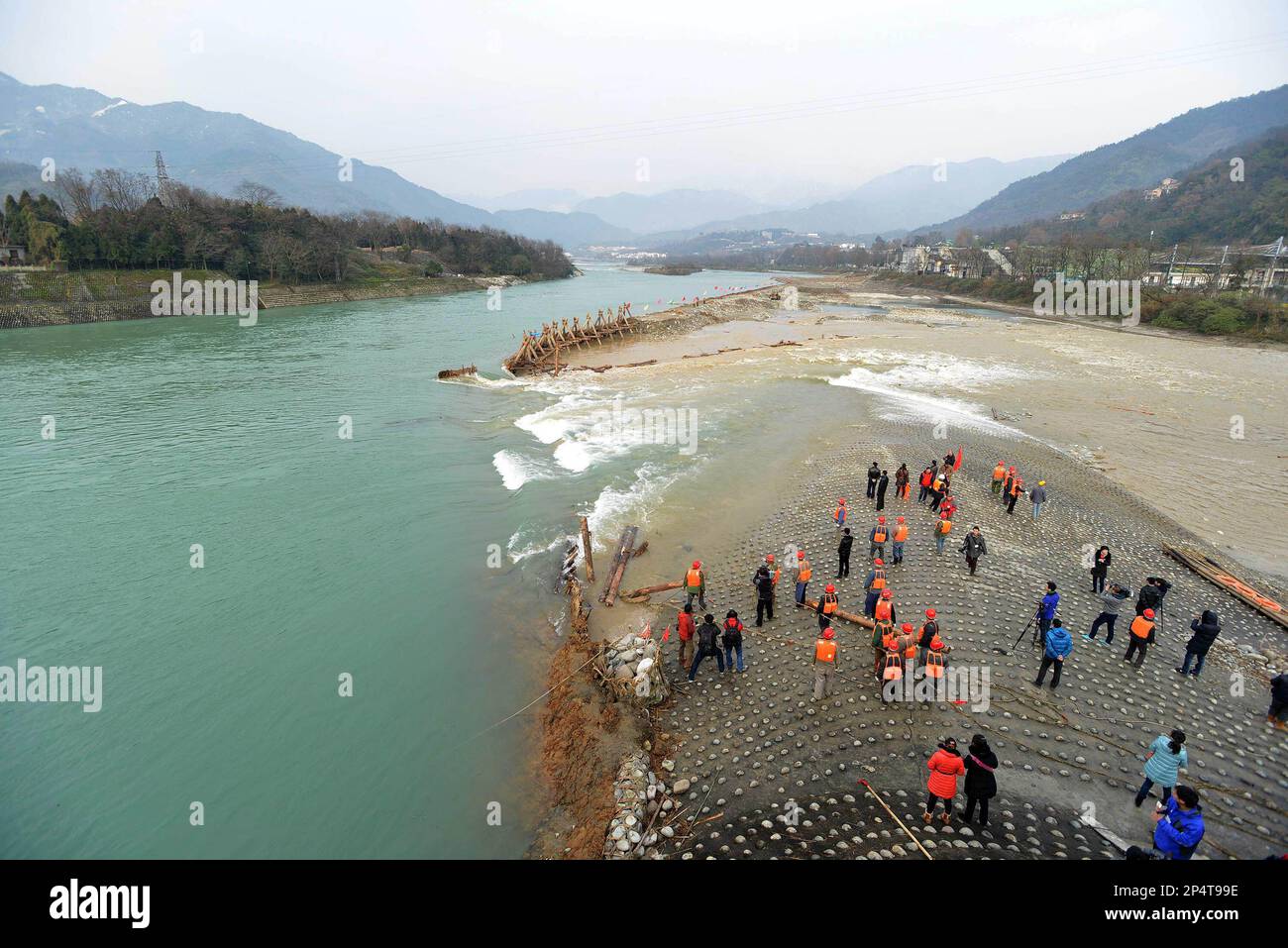 Workers remove the tree branches to release water to the inner river of ...