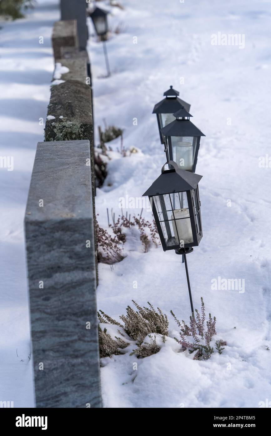 Grave lanterns and tombstones in the cemetery in winter Stock Photo - Alamy