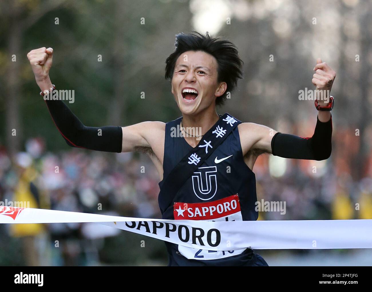 Kento Otsu of Toyo Universtiy breaks a goal tape as his school wins the ...