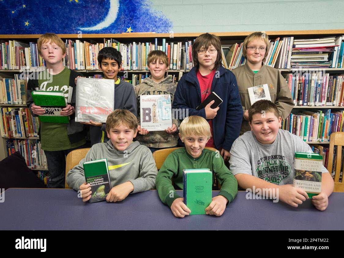 Capital Day School sixth-graders pose for a photo with books the group ...