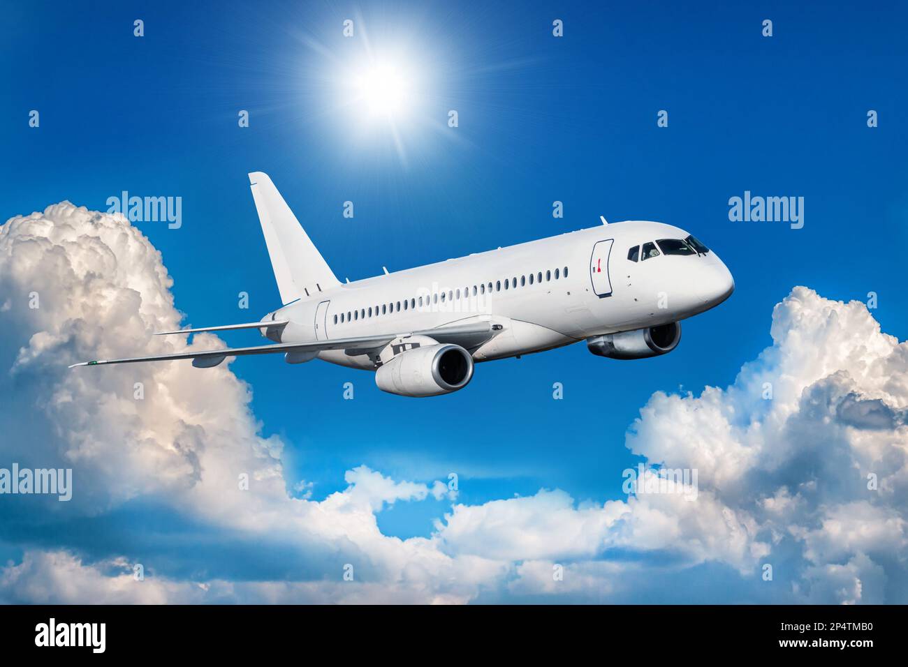 White passenger jetliner fly in the air above picturesque clouds Stock ...