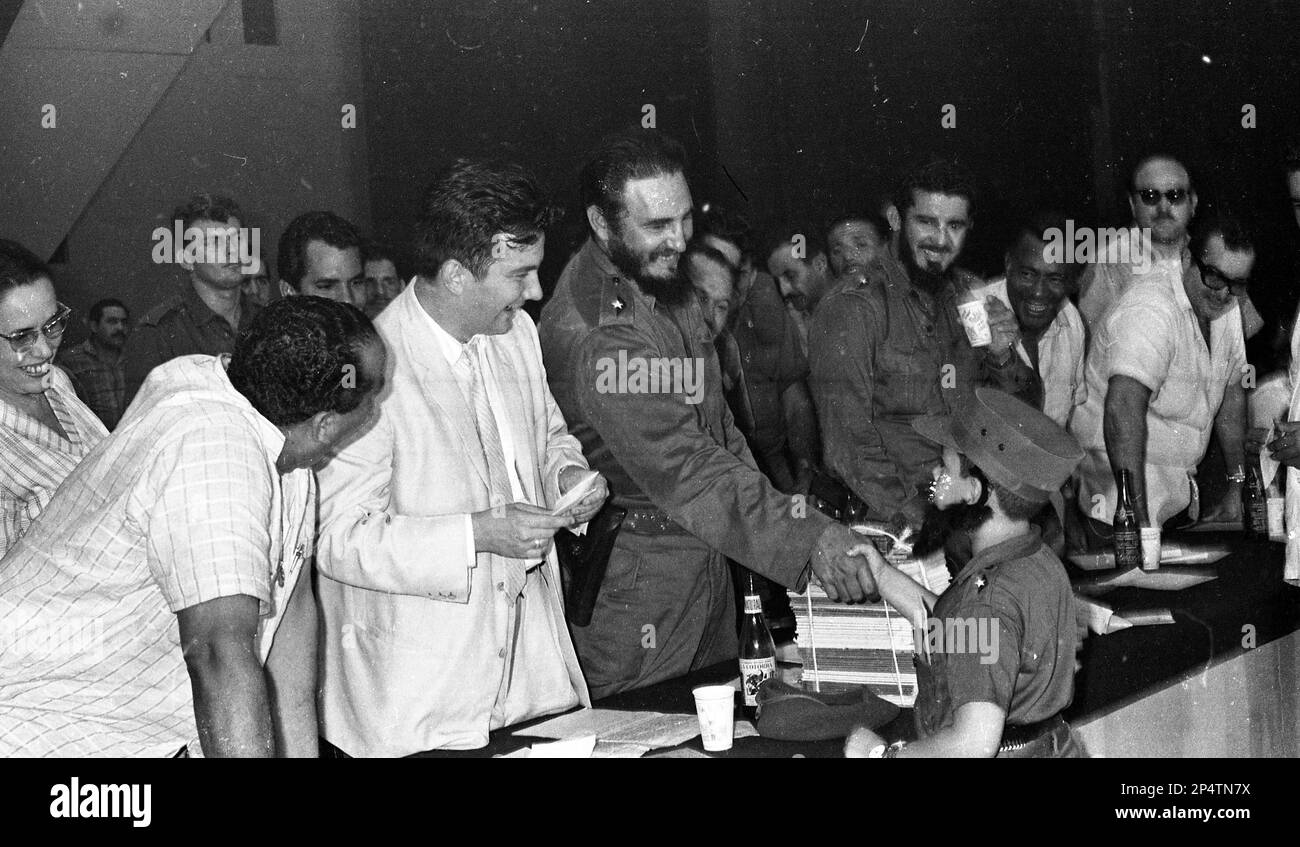 Cuban President Fidel Castro shakes hands with an unidentified ...