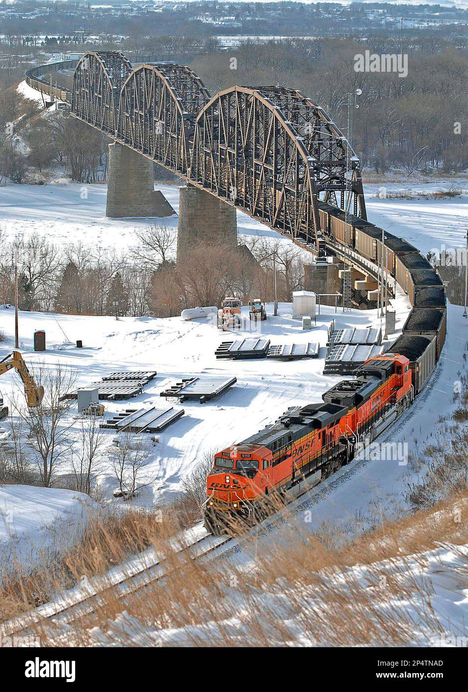An eastbound BNSF train crosses a trestle over the Missouri River ...