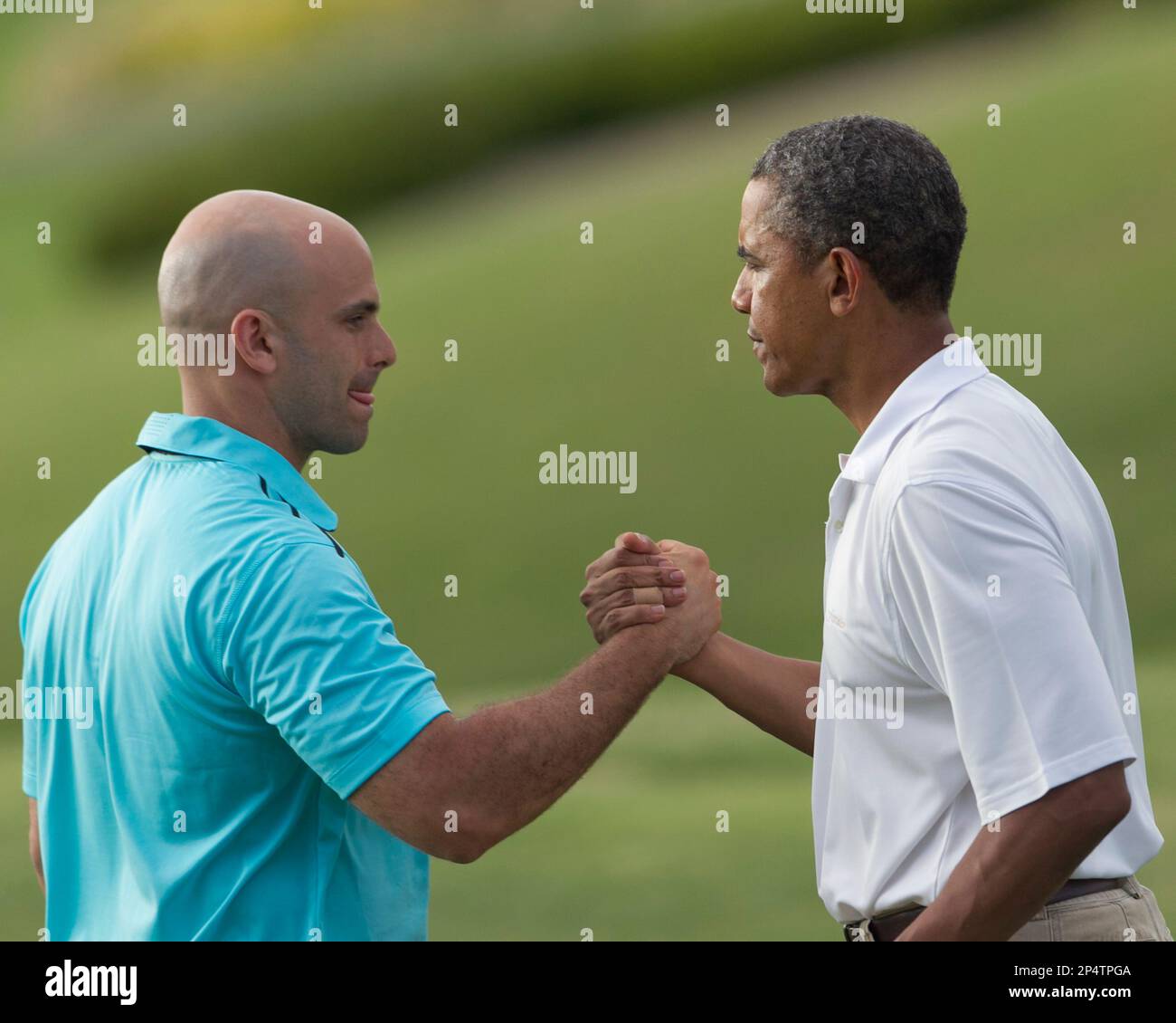 President Barack Obama shakes hands with playing partner Sam Kass after ...