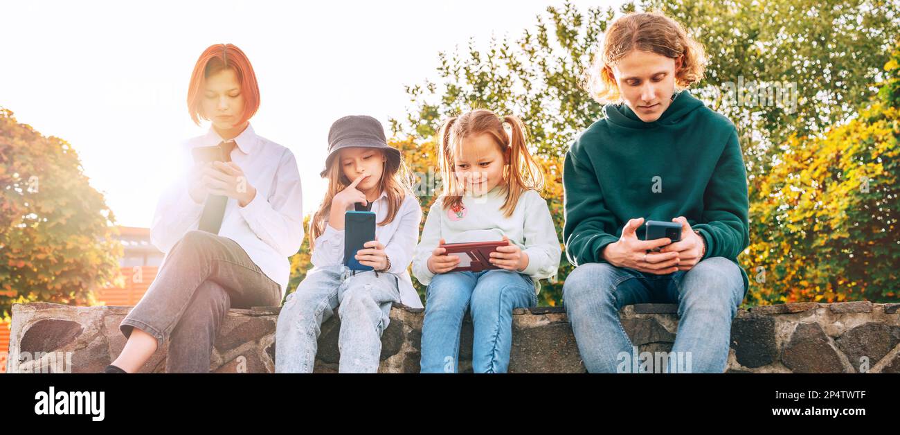 Teenager boy and a sister girls kids sitting and browsing their ...
