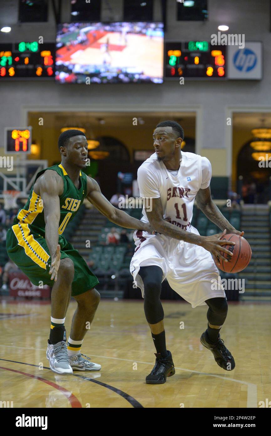 Saint Joseph's forward Daryus Quarles (11) drives in front of Siena ...