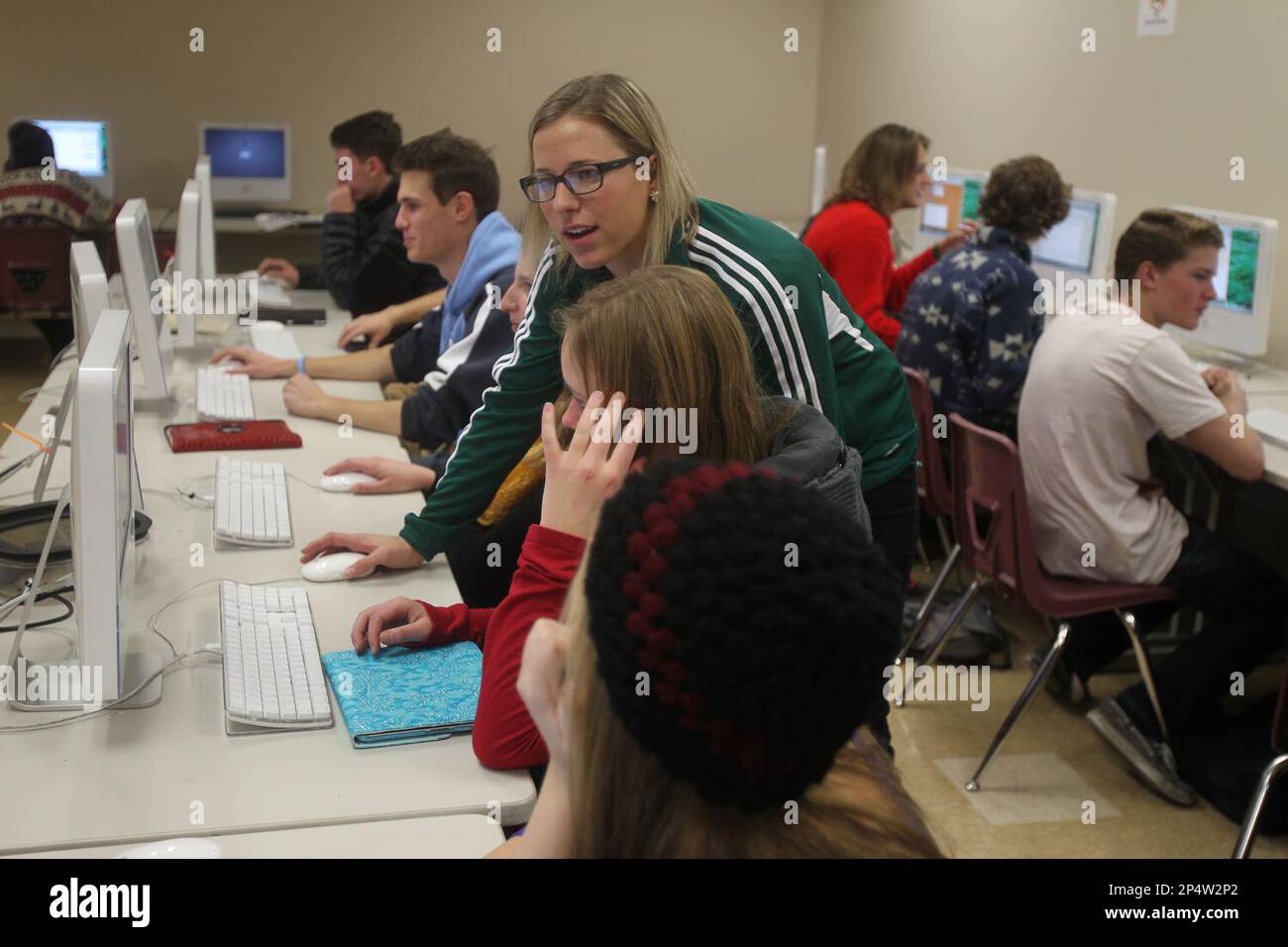 This photo taken Dec. 20, 2013, shows Erika Strauser, standing, who ...