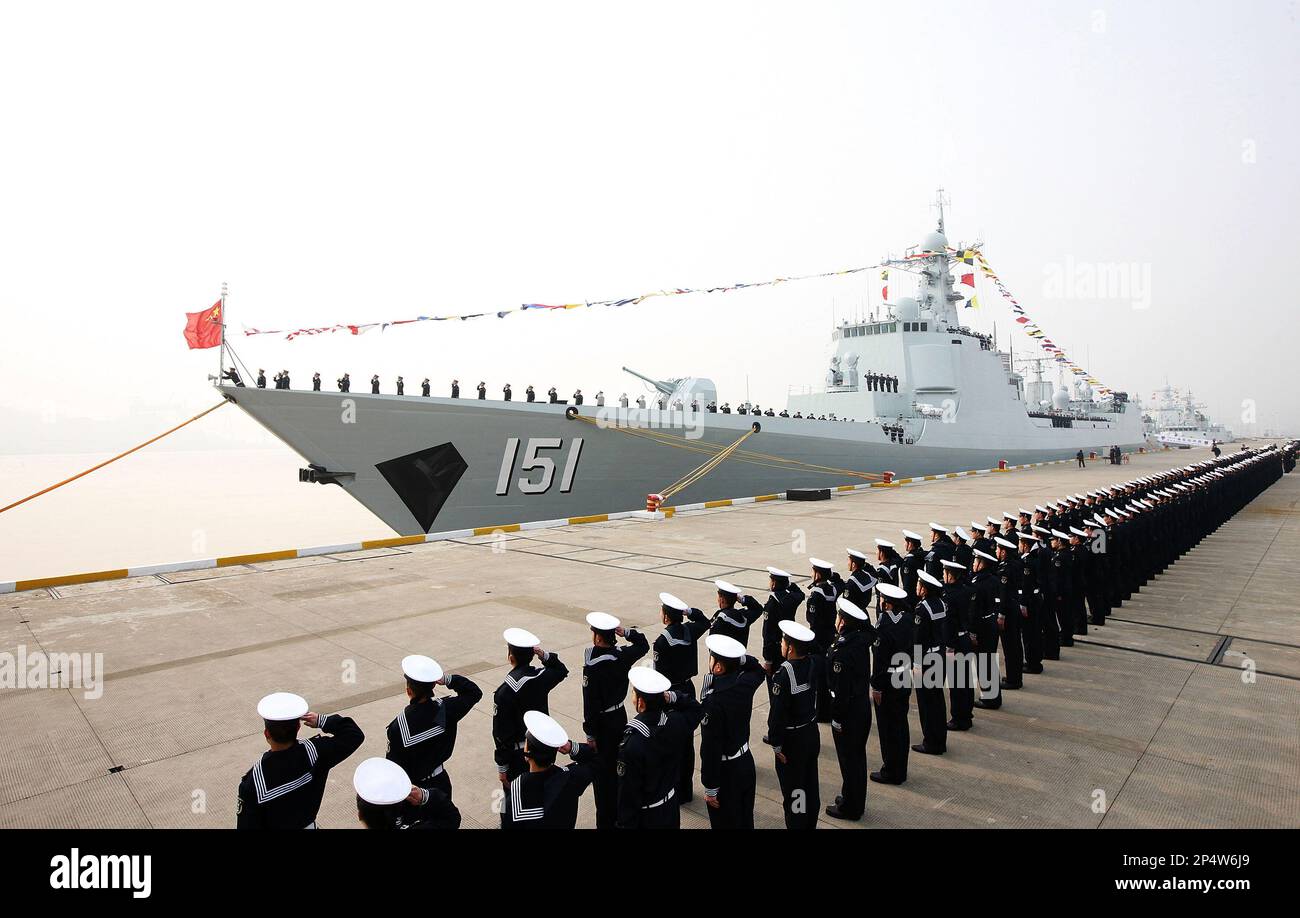 Chinese soldiers salute in front of the new China-made Type 052C guided missile destroyer ...
