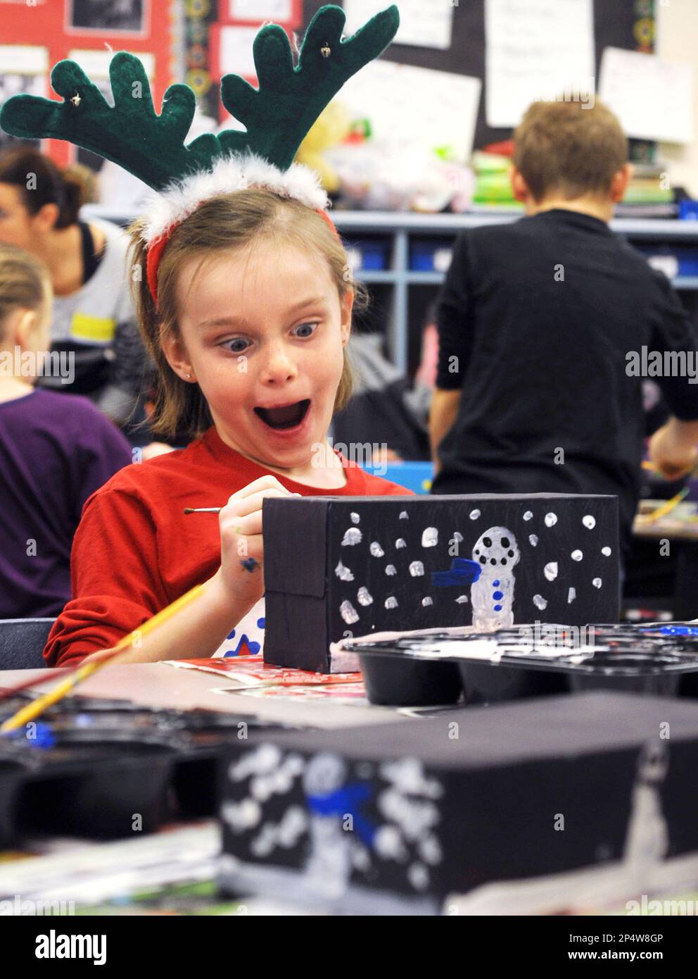 This Dec. 18, 2013 photo shows Mallory Velotta, 7, painting a tissue ...