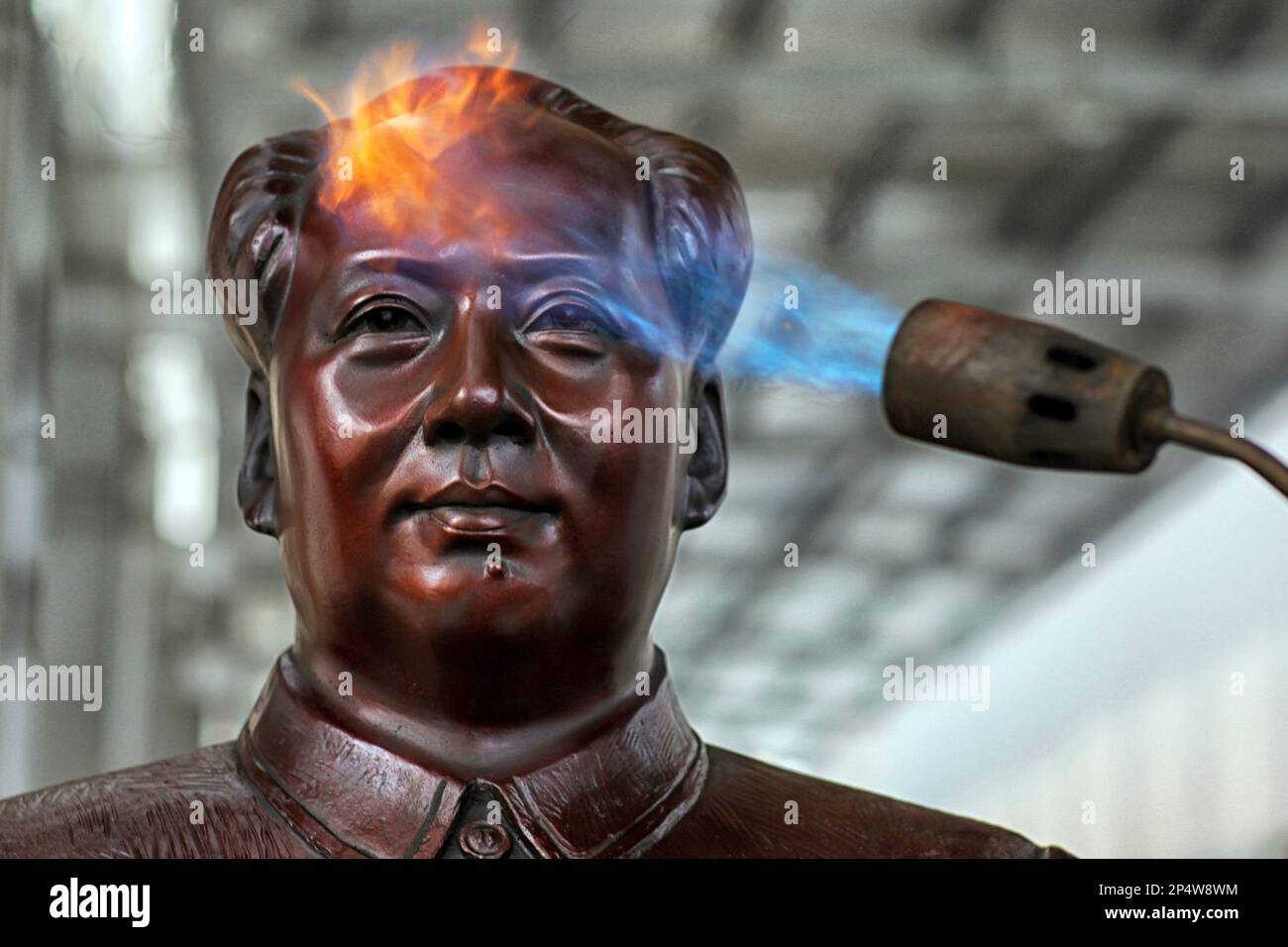 In this Dec. 5, 2013 photo, a worker uses a torch to process a statue ...