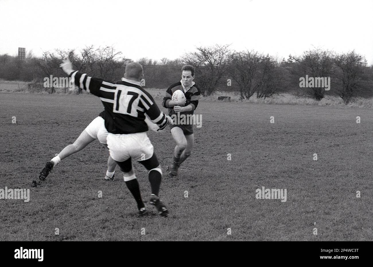 1980s, amateur rugby union, a wing player with ball in hand trying to ...